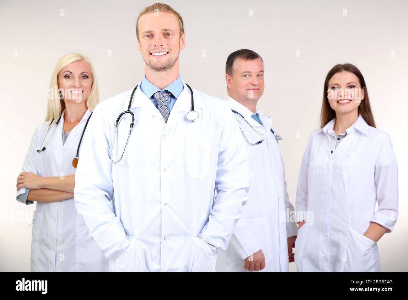 Medical workers on grey background Stock Photo - Alamy