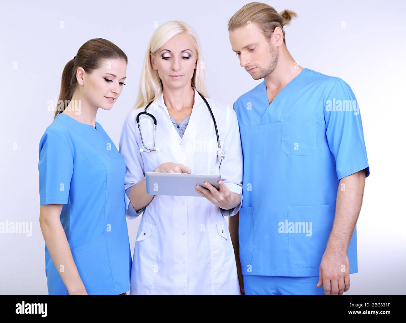 Medical workers on grey background Stock Photo - Alamy