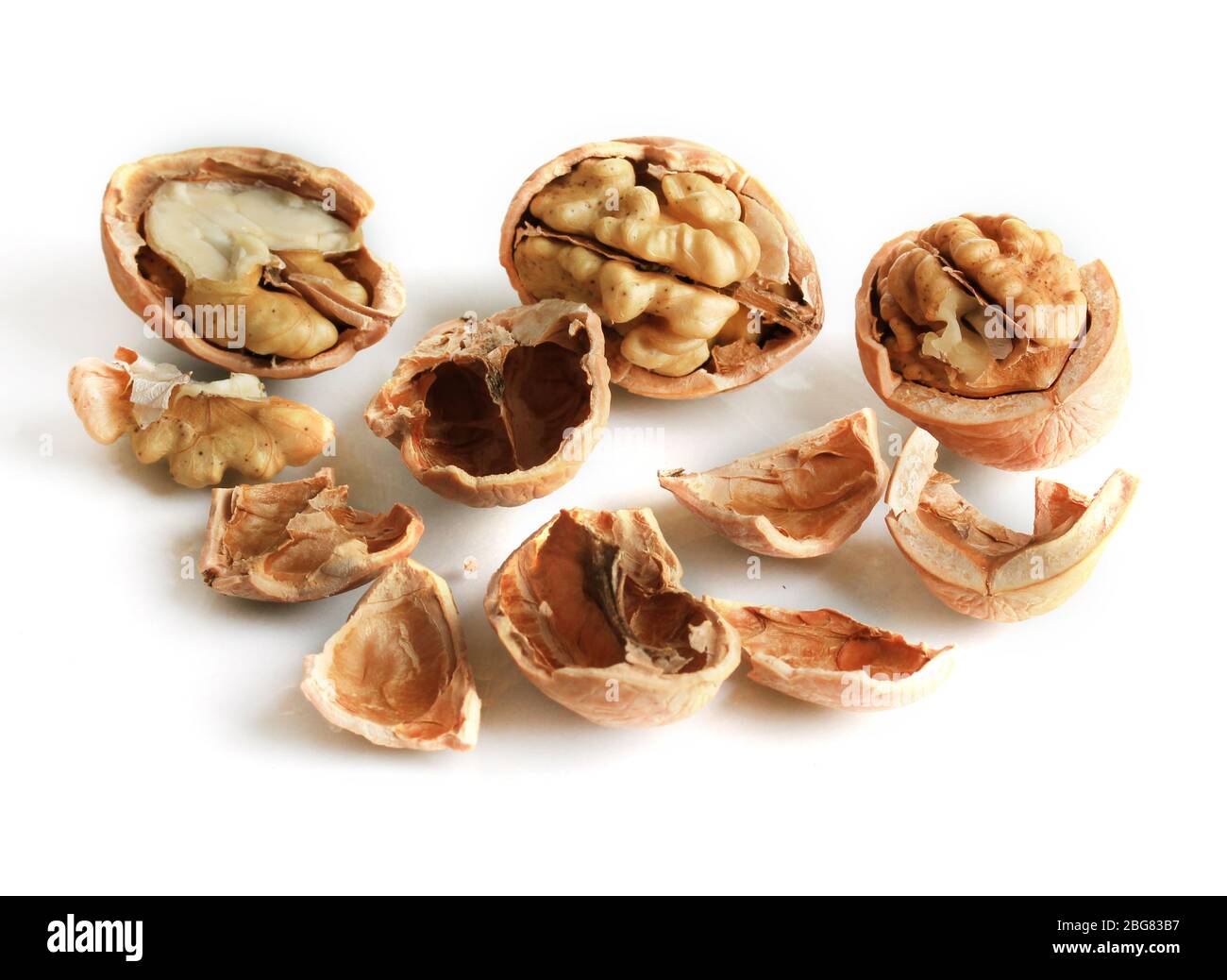 Broken walnuts isolated on white Stock Photo - Alamy
