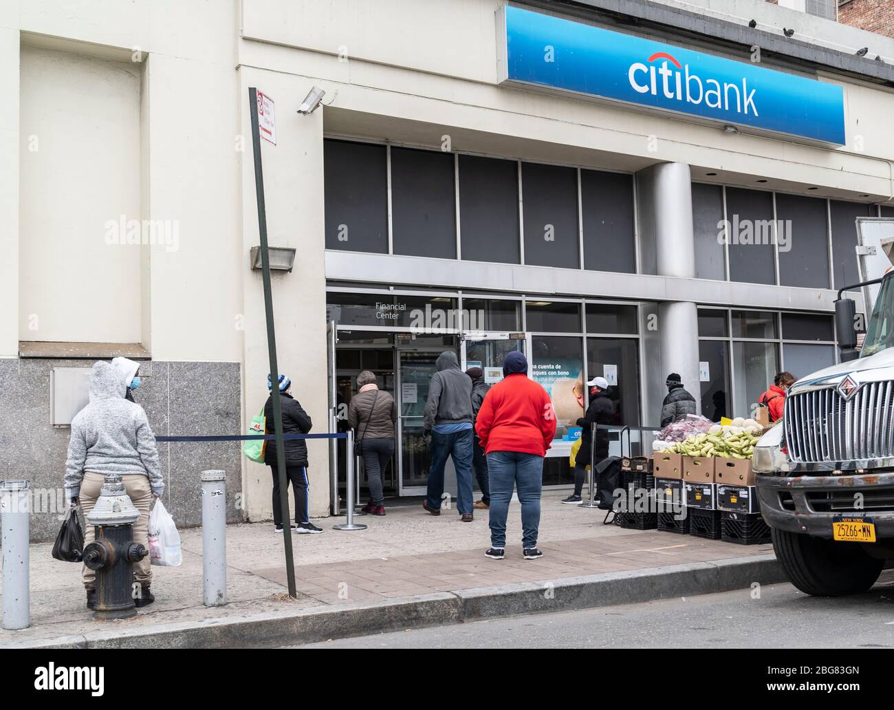 New York, NY - April 20, 2020: Long line of people waiting to withdraw ...