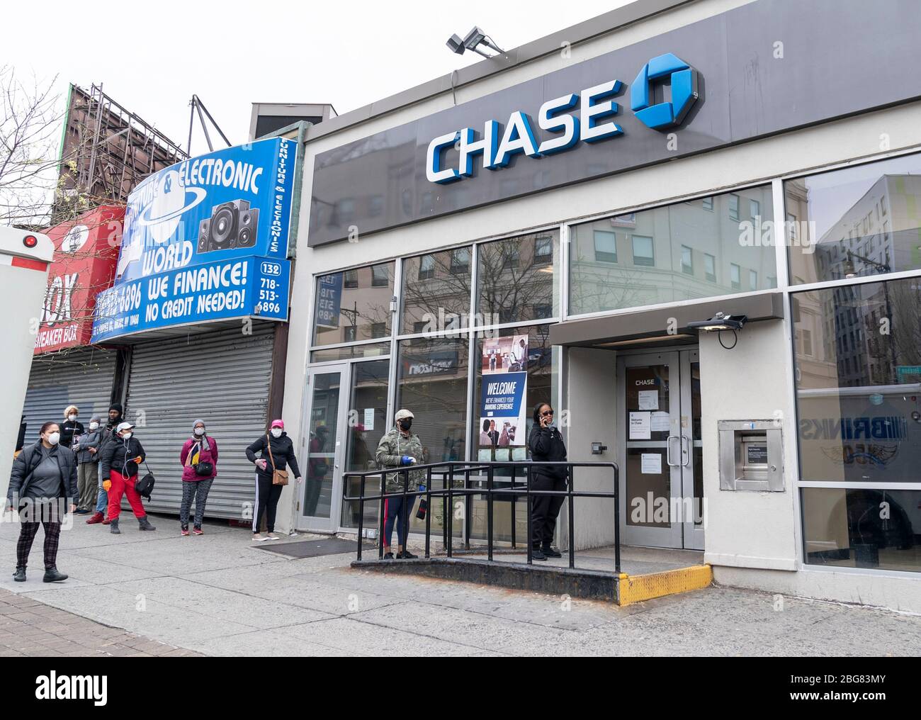 New York, NY - April 20, 2020: Long line of people waiting to withdraw ...
