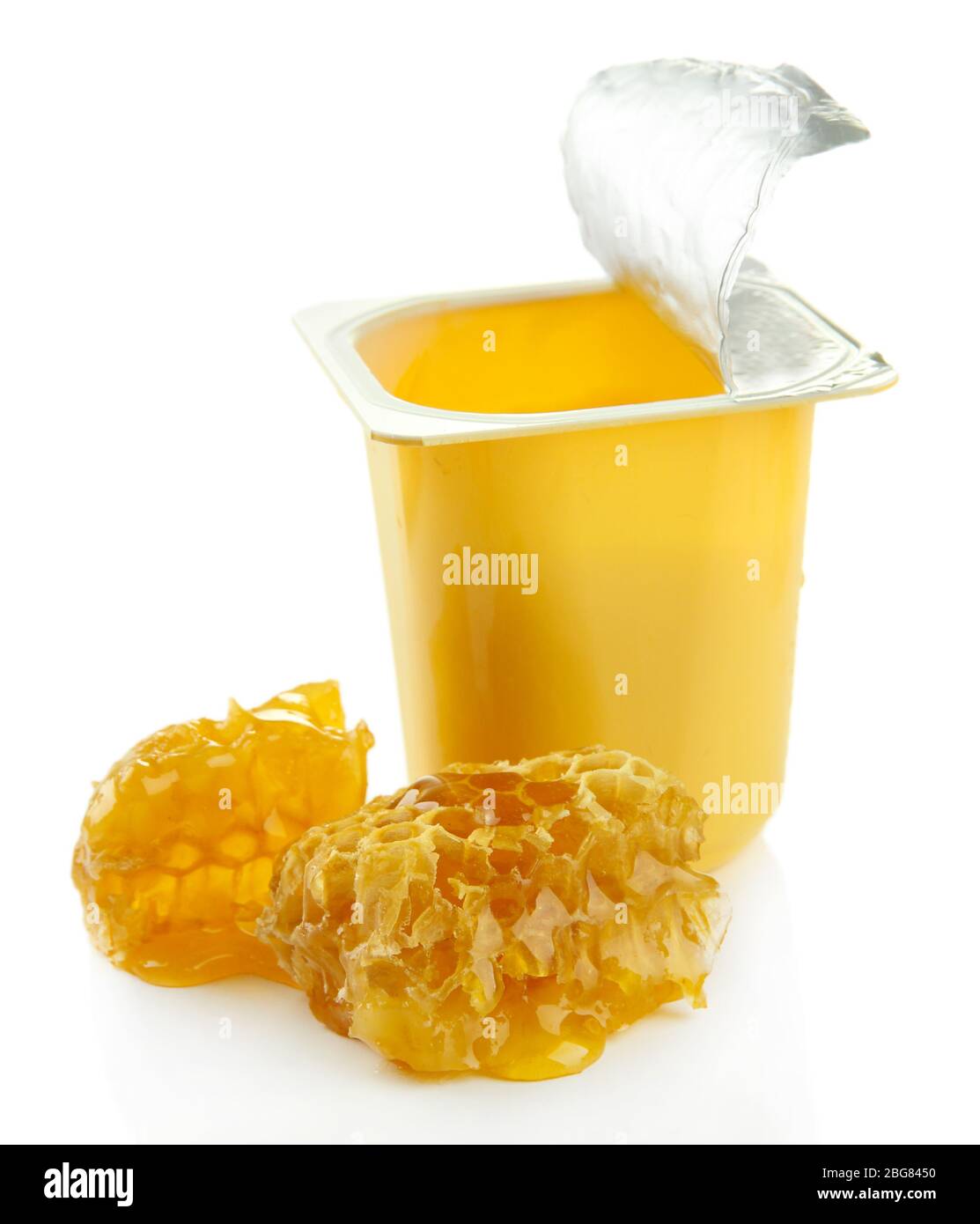 Tasty dessert in open plastic cup and honey combs, isolated on white ...