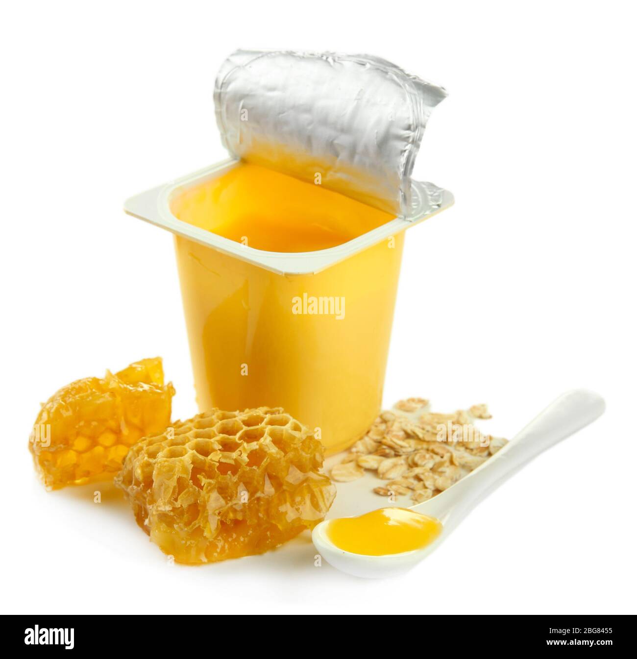 Tasty dessert in open plastic cup and honey combs, isolated on white ...