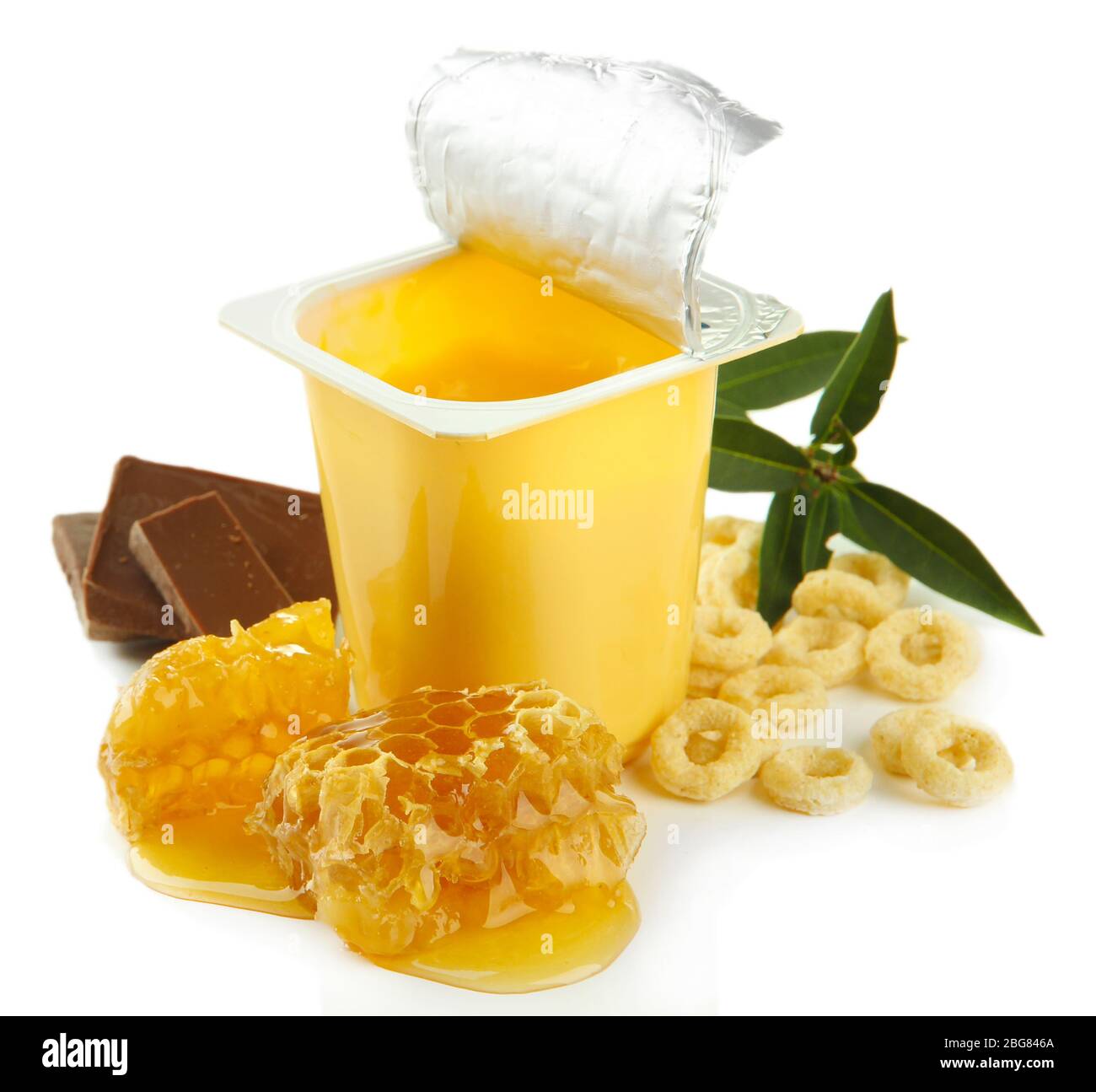 Tasty dessert in open plastic cup and honey combs, isolated on white ...