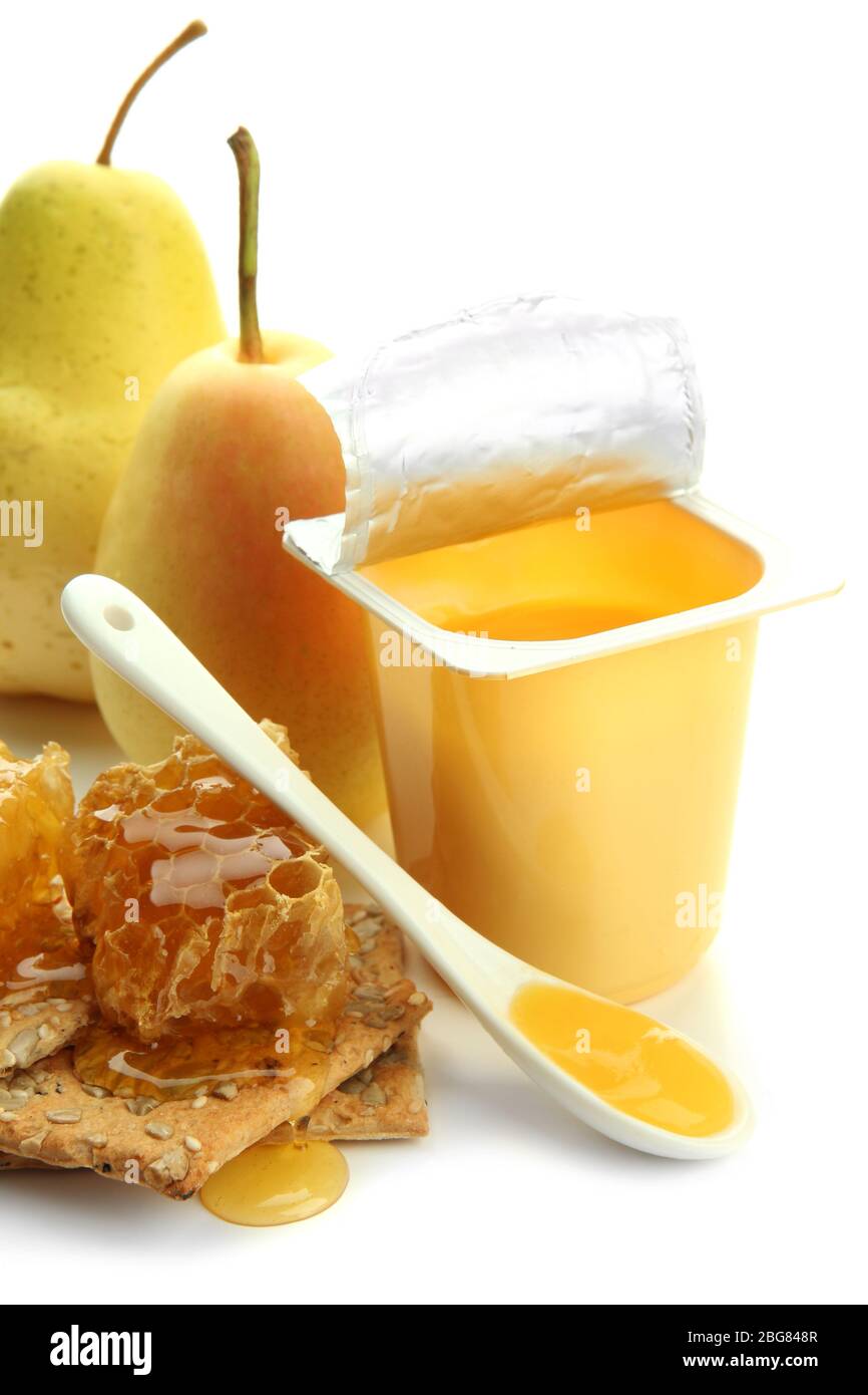 Tasty desserts in open plastic cups and honey combs, fruits, isolated ...