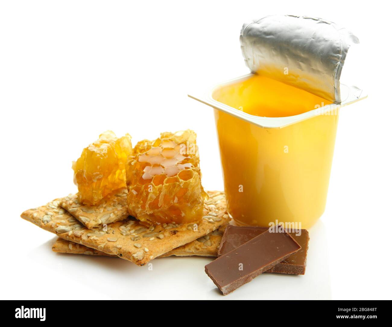 Tasty dessert in open plastic cup and honey combs, isolated on white ...