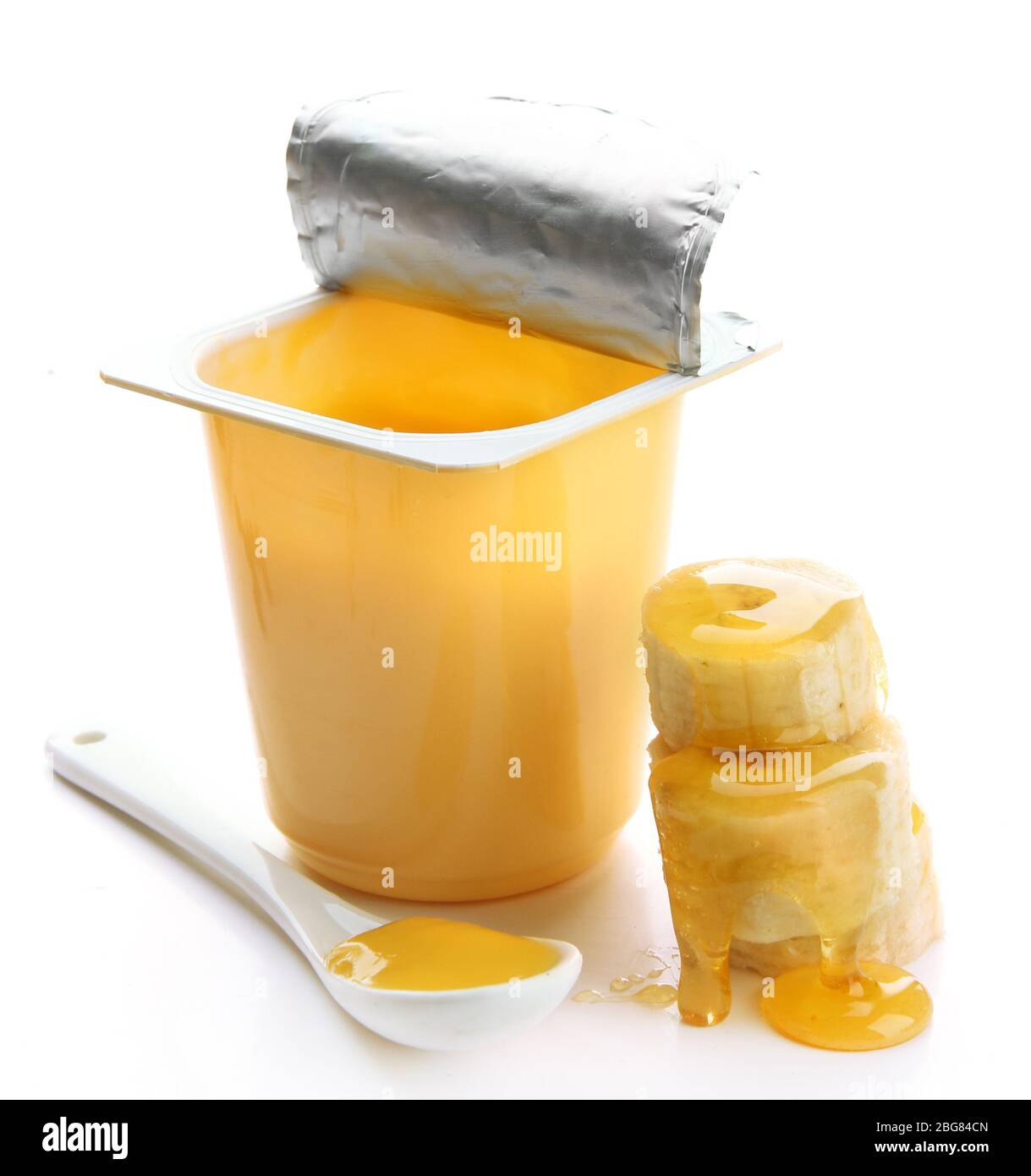 Tasty dessert in open plastic cup and banana, isolated on white Stock ...