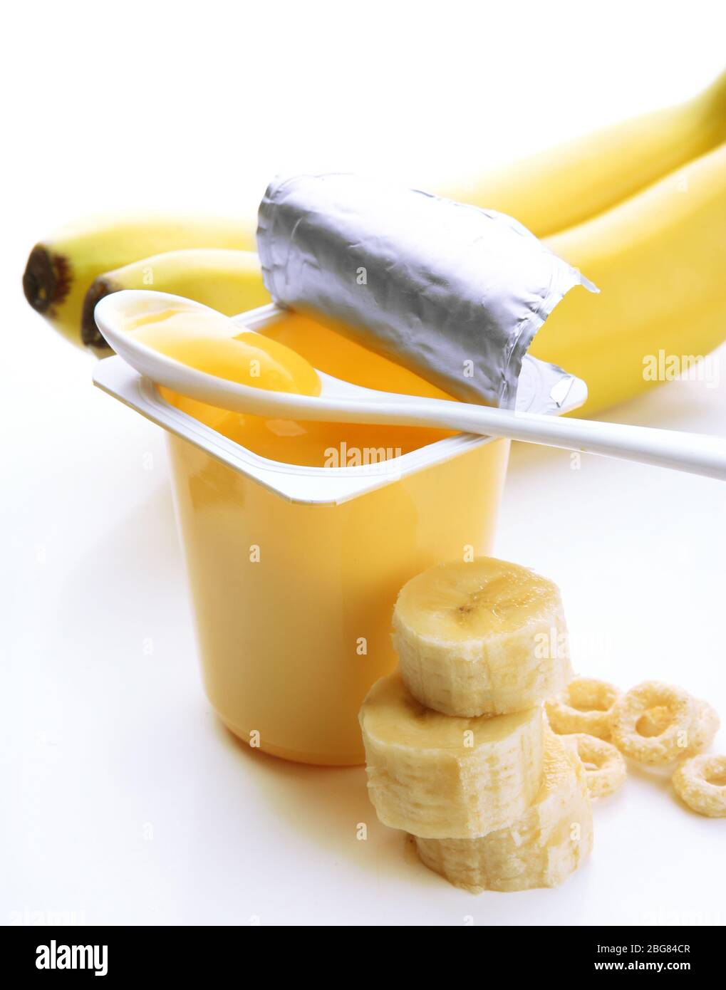 Tasty dessert in open plastic cup and banana, isolated on white Stock ...