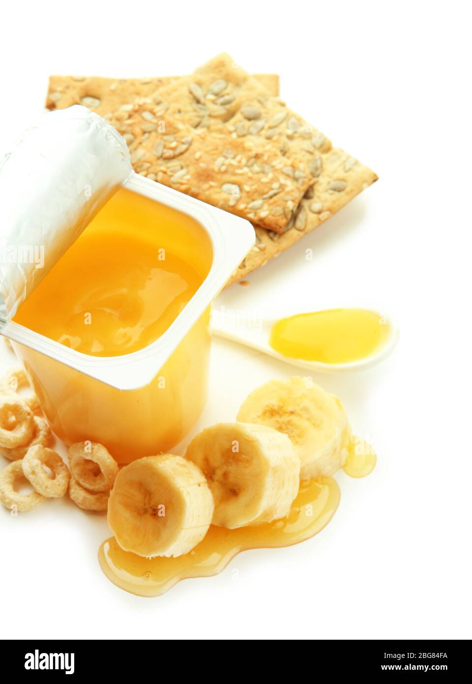 Tasty dessert in open plastic cup and banana, isolated on white Stock ...