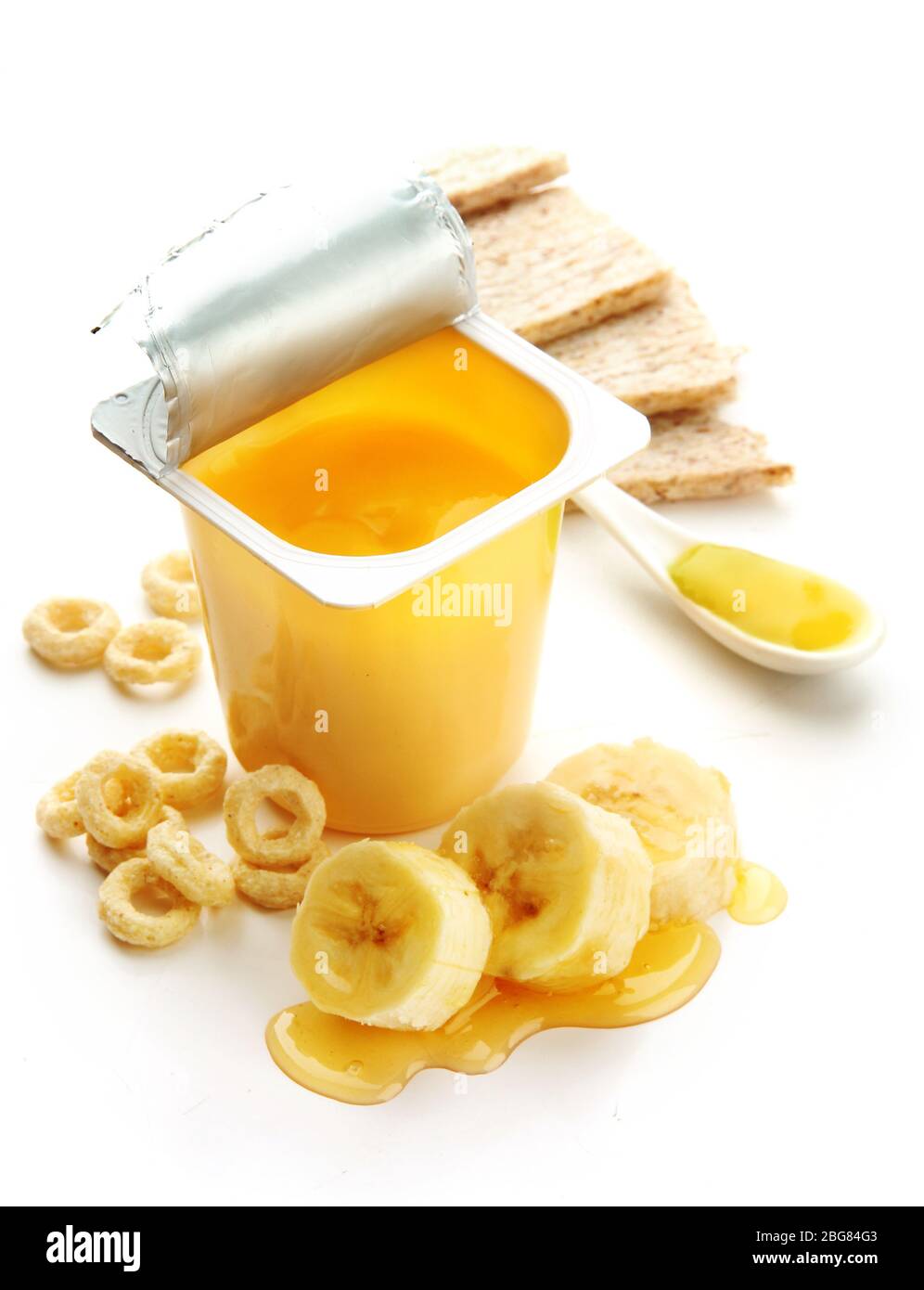 Tasty dessert in open plastic cup and banana, isolated on white Stock ...