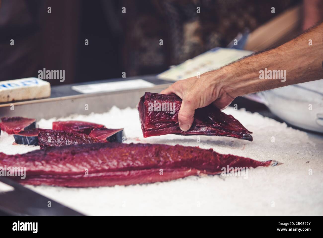 A fishmonger cutting a tuna Fish in a Málaga market Stock Photo - Alamy