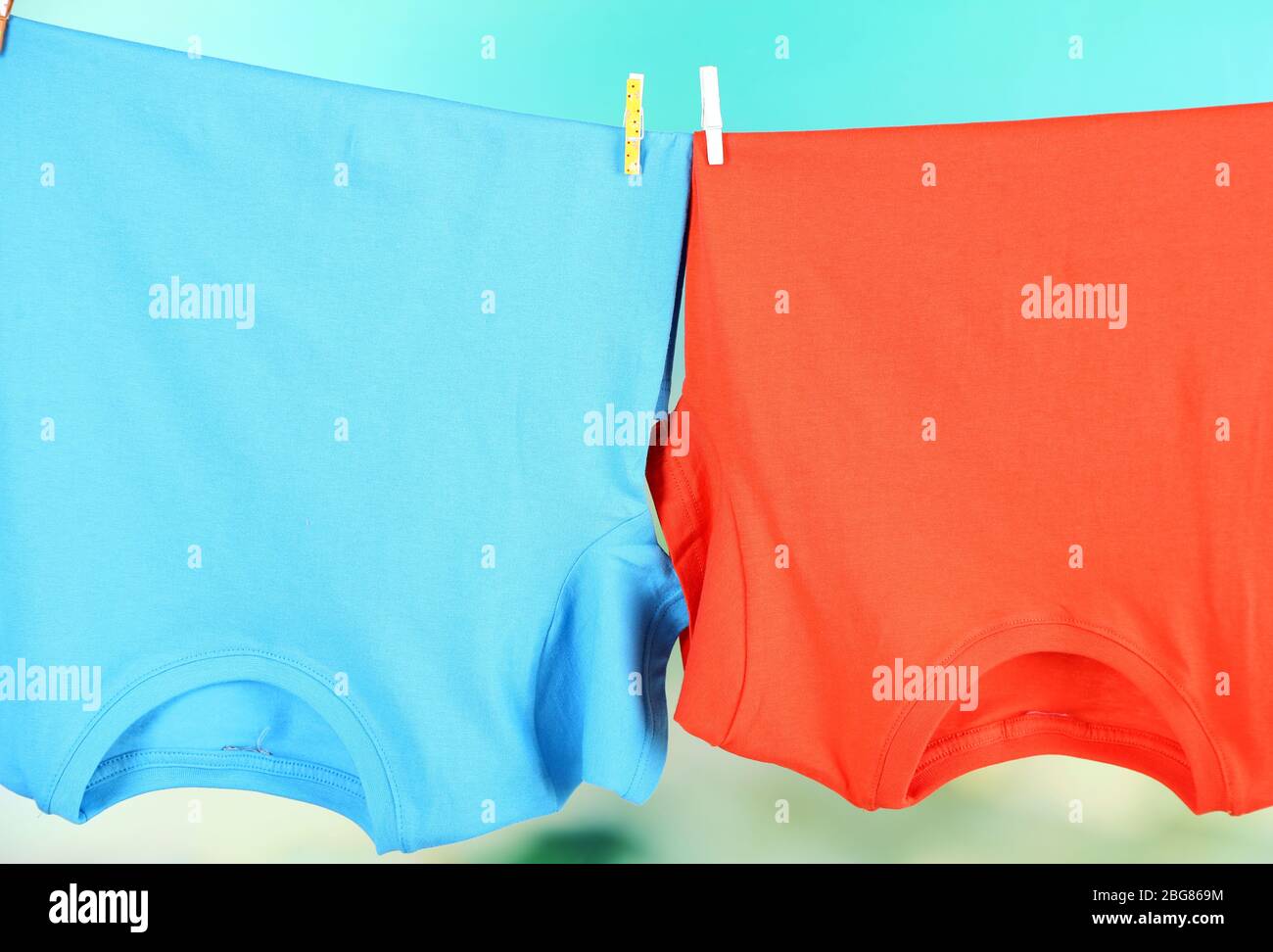 Shirts on rope on nature background Stock Photo - Alamy