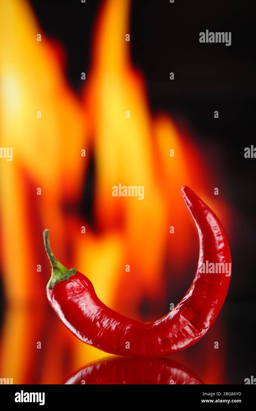 Red hot chili pepper on fire background Stock Photo - Alamy