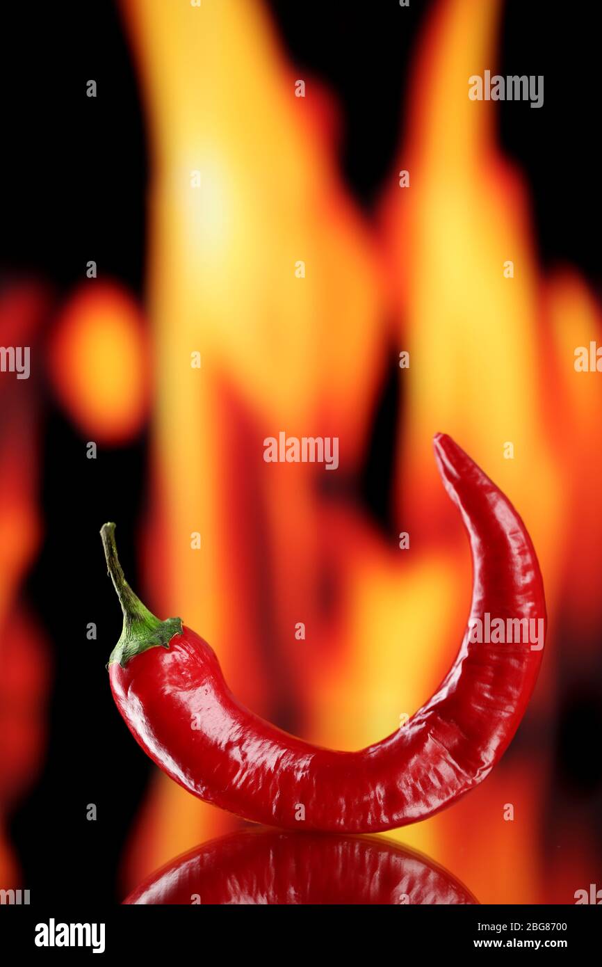 Red hot chili pepper on fire background Stock Photo - Alamy