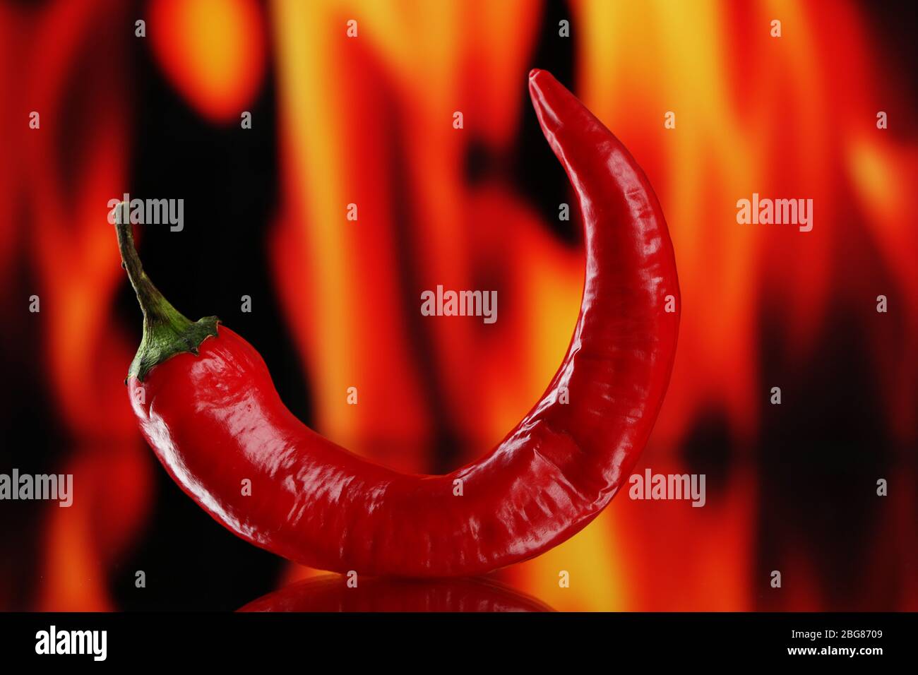 Red hot chili pepper on fire background Stock Photo - Alamy