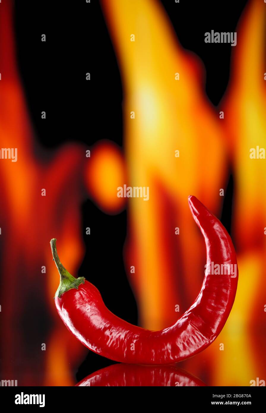 Red hot chili pepper on fire background Stock Photo - Alamy