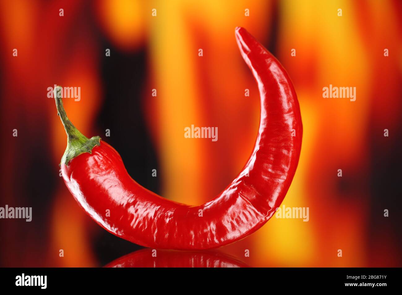 Red hot chili pepper on fire background Stock Photo - Alamy