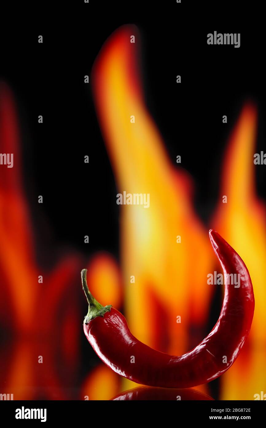 Red hot chili pepper on fire background Stock Photo - Alamy