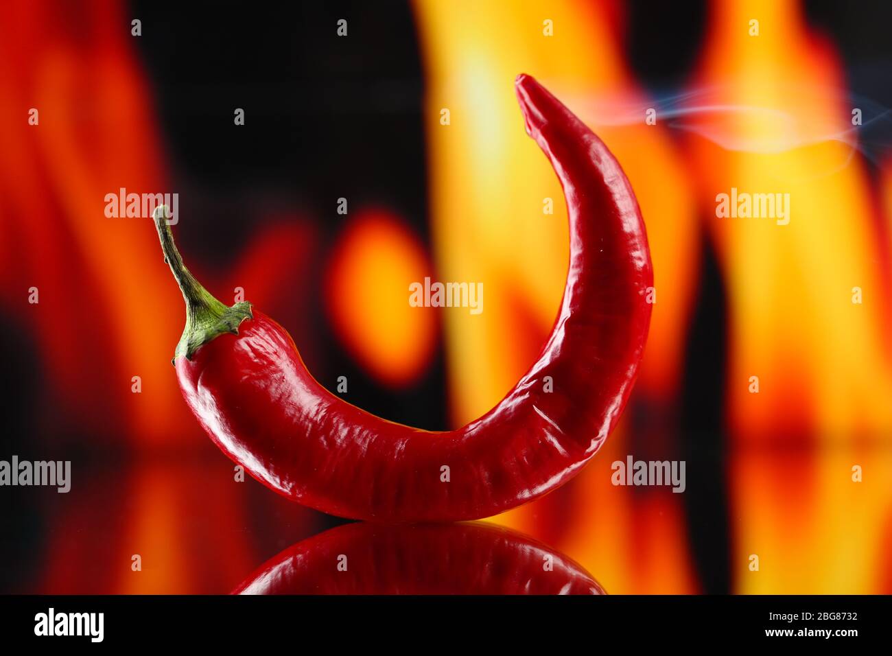Red hot chili pepper on fire background Stock Photo - Alamy