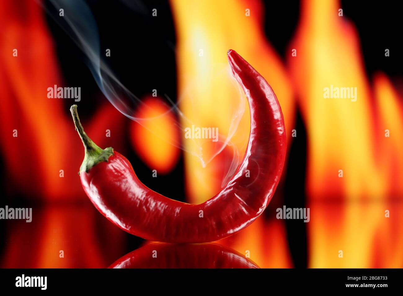 Red hot chili pepper on fire background Stock Photo - Alamy