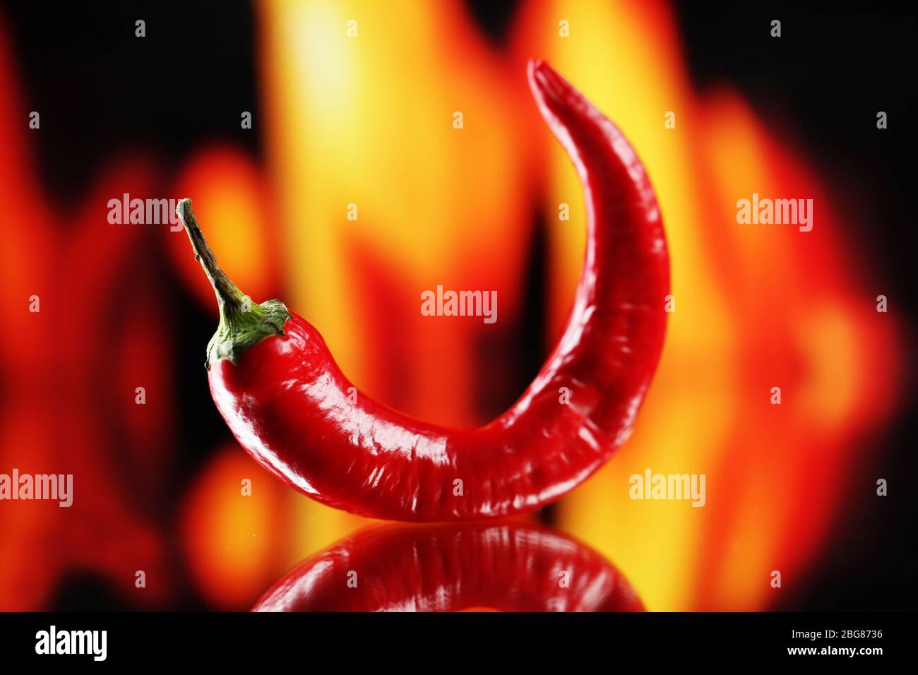 Red hot chili pepper on fire background Stock Photo - Alamy