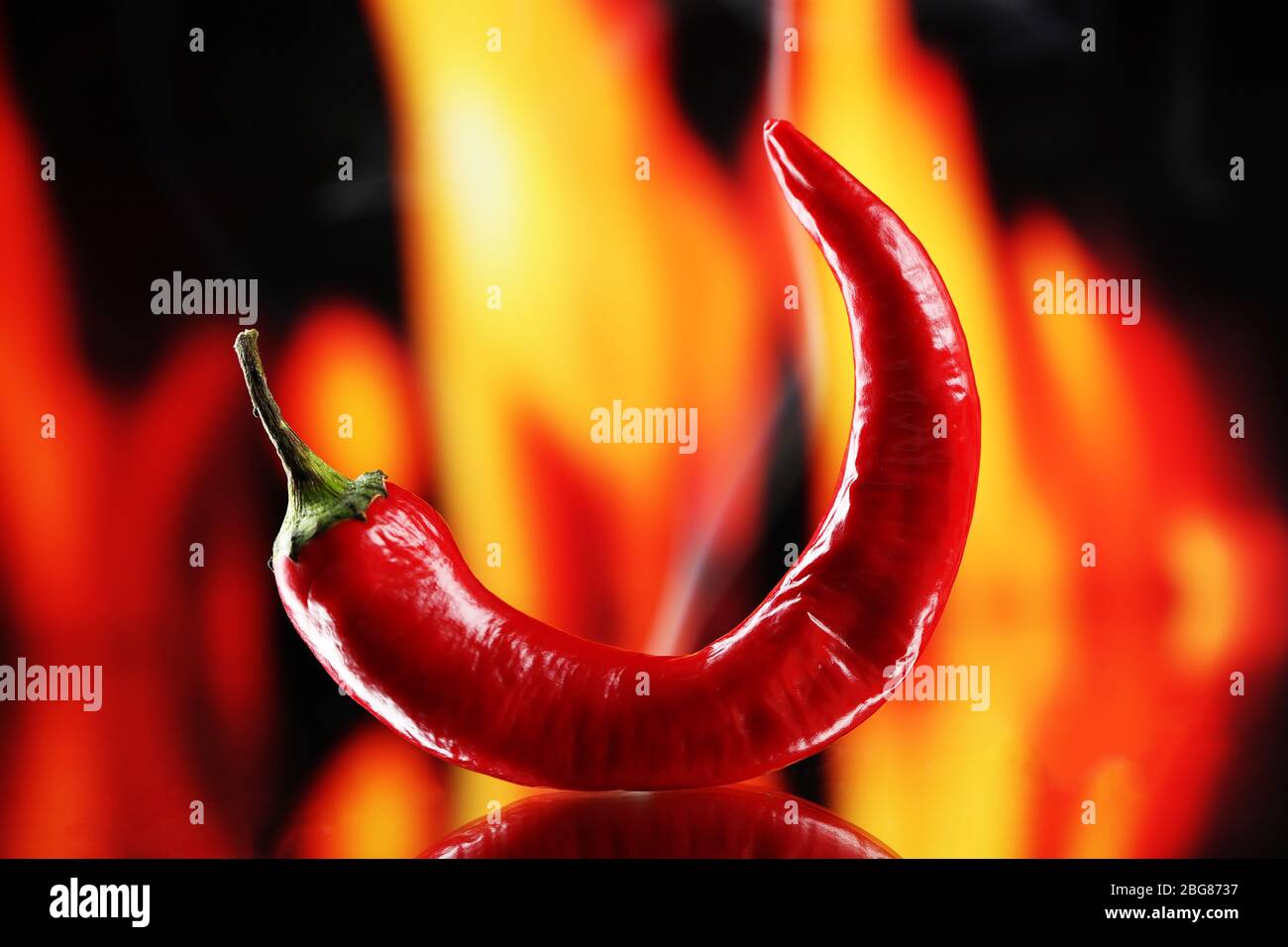 Red hot chili pepper on fire background Stock Photo - Alamy