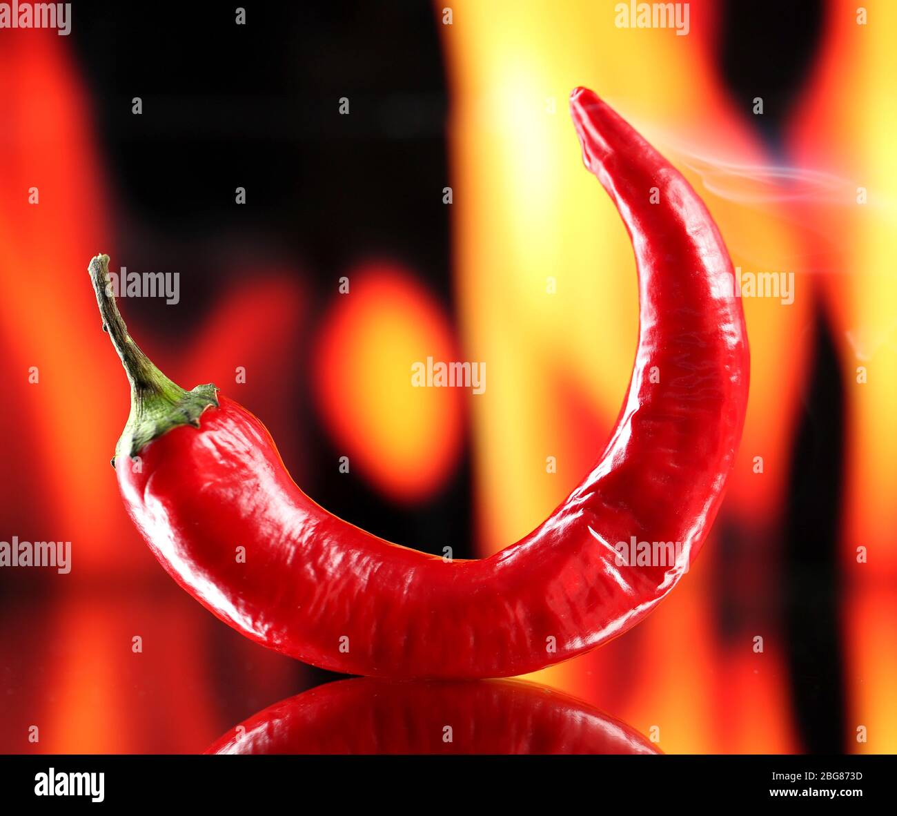 Red hot chili pepper on fire background Stock Photo - Alamy