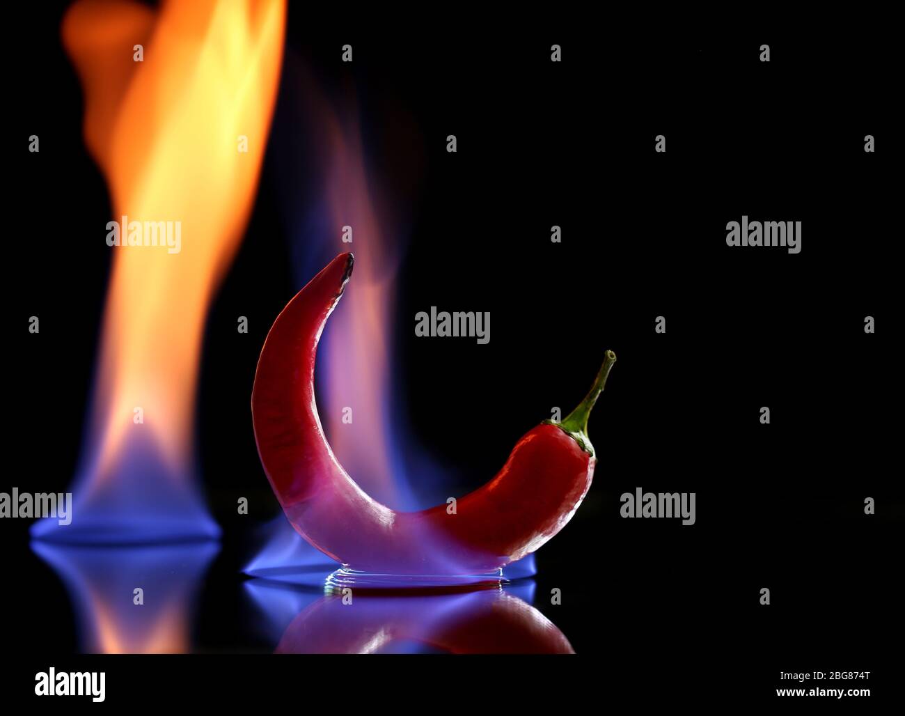 Red hot chili pepper on fire, isolated on black Stock Photo - Alamy