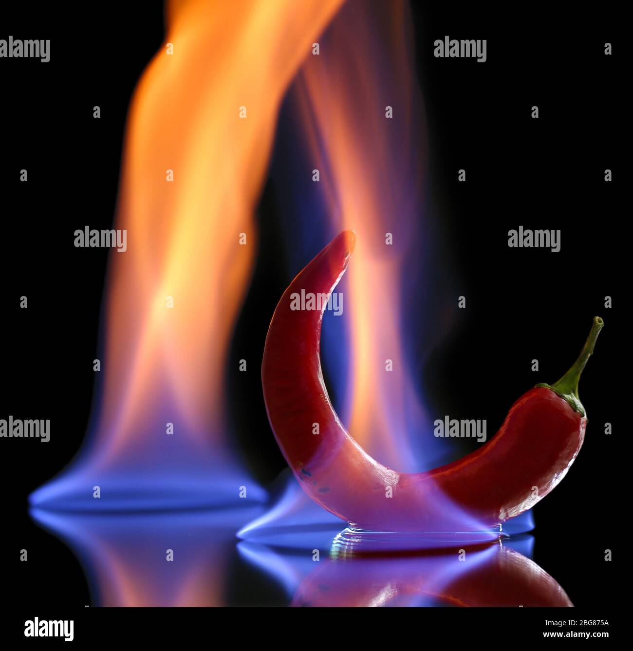 Red hot chili pepper on fire, isolated on black Stock Photo - Alamy
