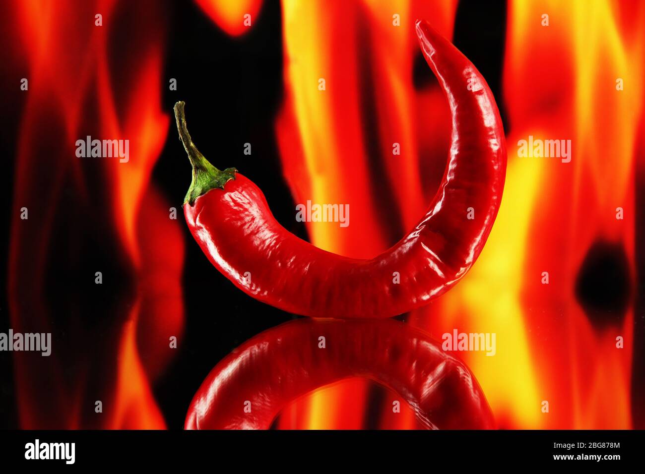 Red hot chili pepper on fire background Stock Photo - Alamy