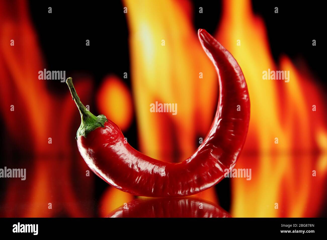 Red hot chili pepper on fire background Stock Photo - Alamy