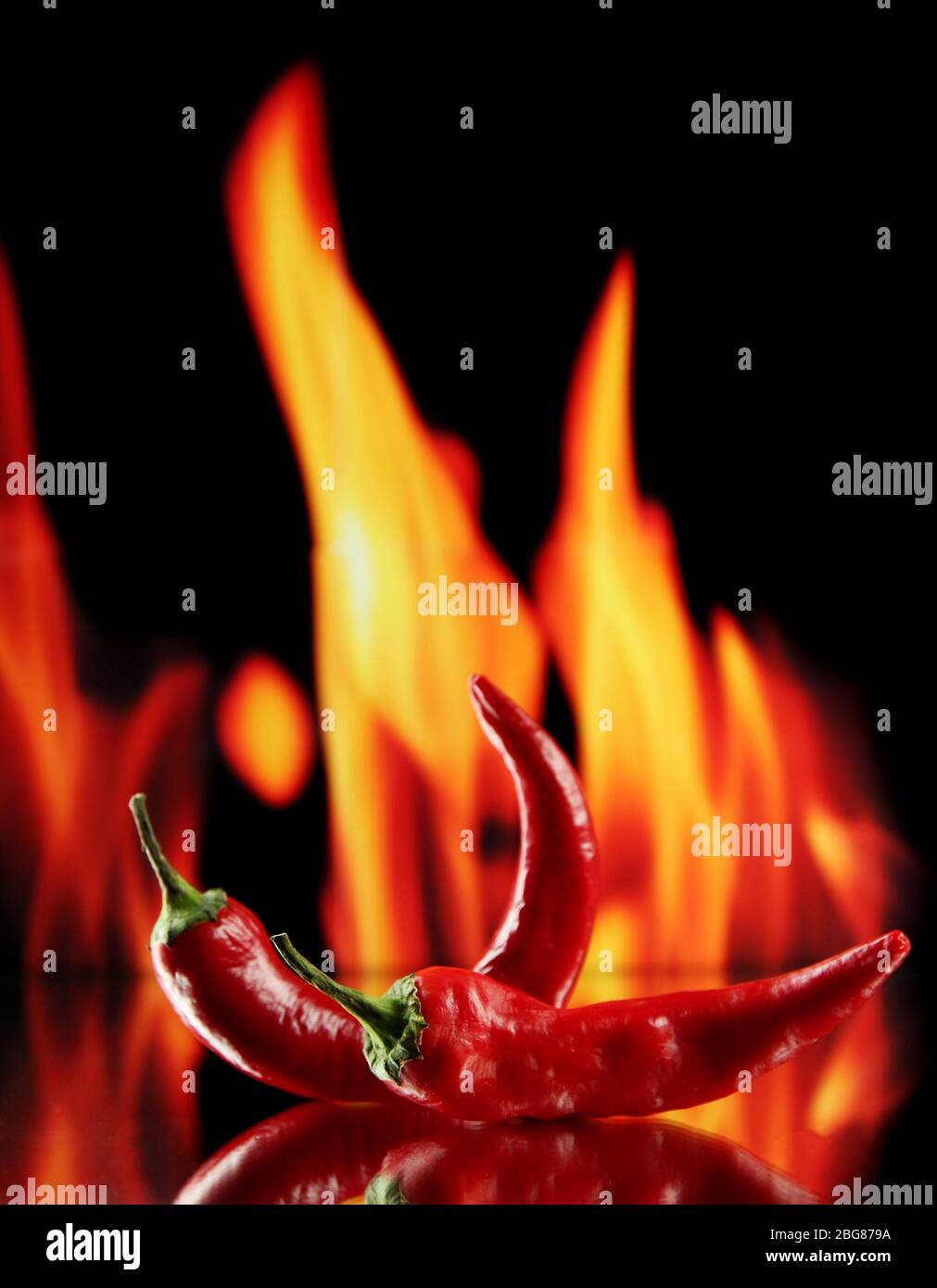 Red hot chili peppers on fire background Stock Photo - Alamy