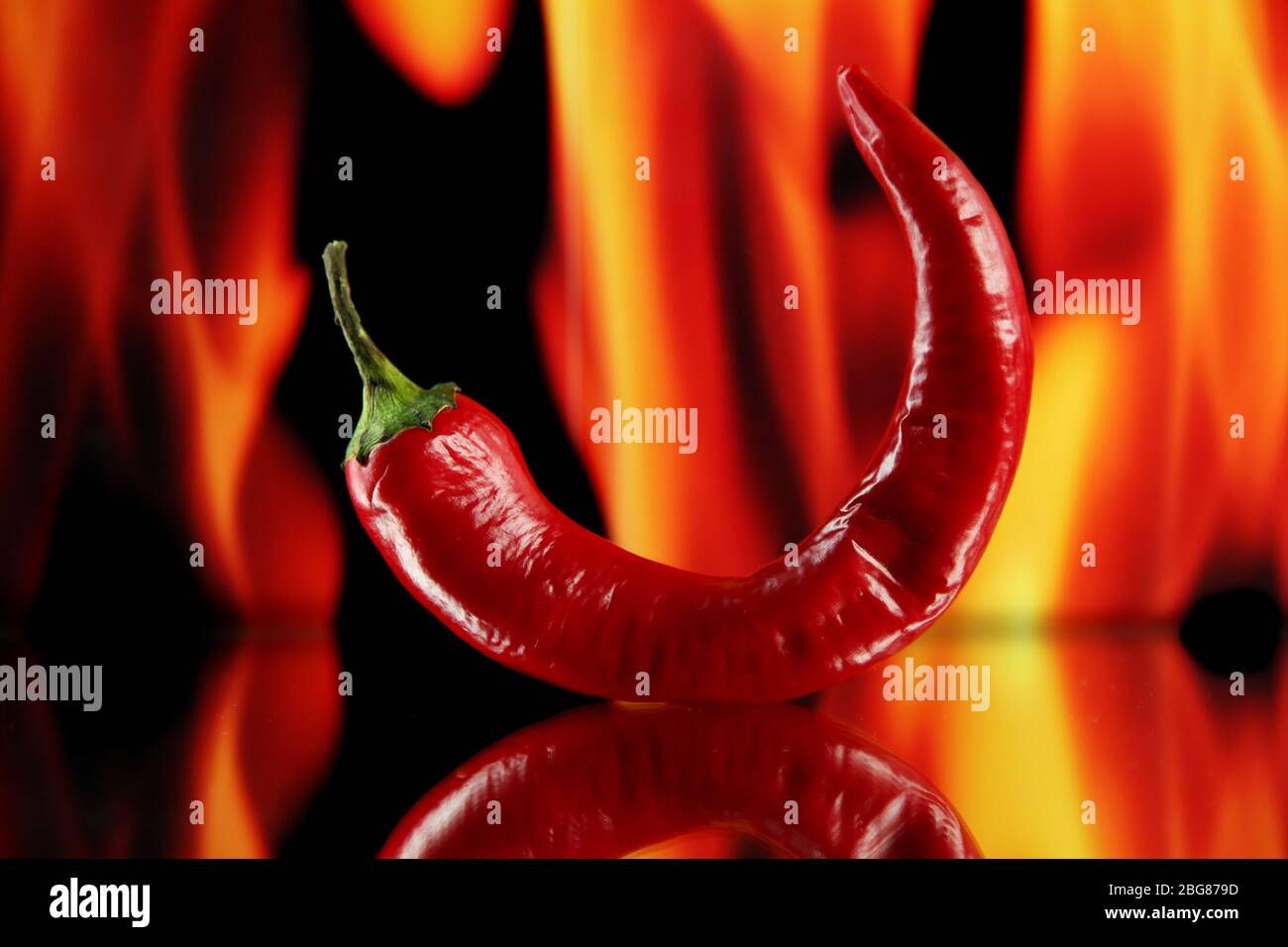 Red hot chili peppers on fire background Stock Photo - Alamy
