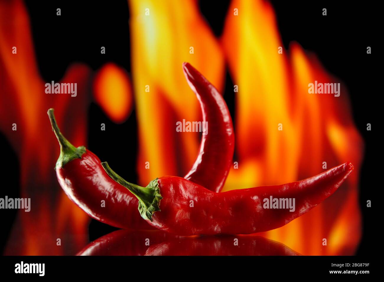 Red hot chili peppers on fire background Stock Photo - Alamy