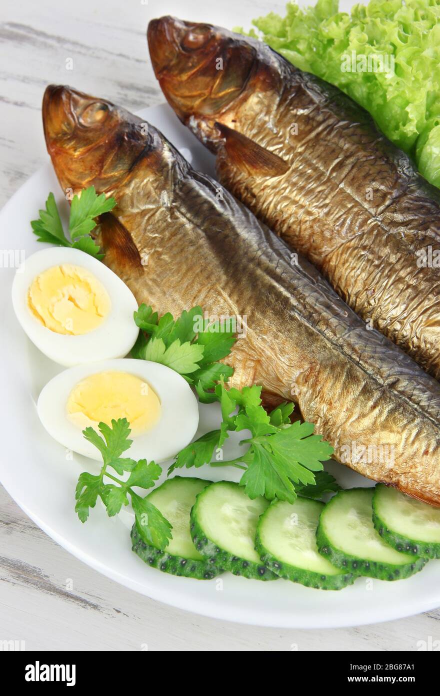Smoked fish on plate close up Stock Photo - Alamy