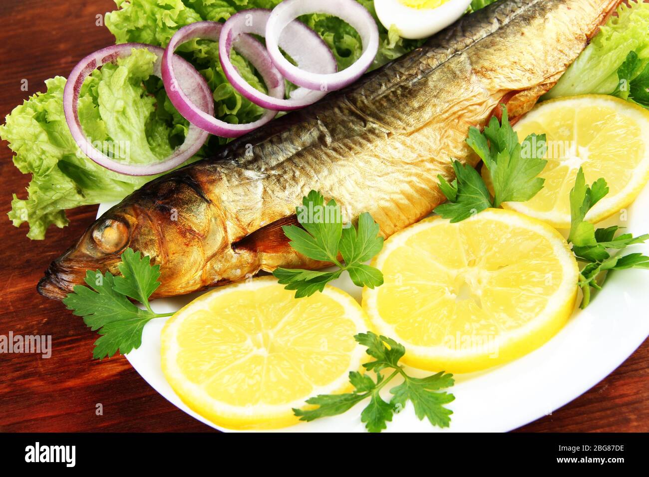 Smoked fish on plate close up Stock Photo - Alamy