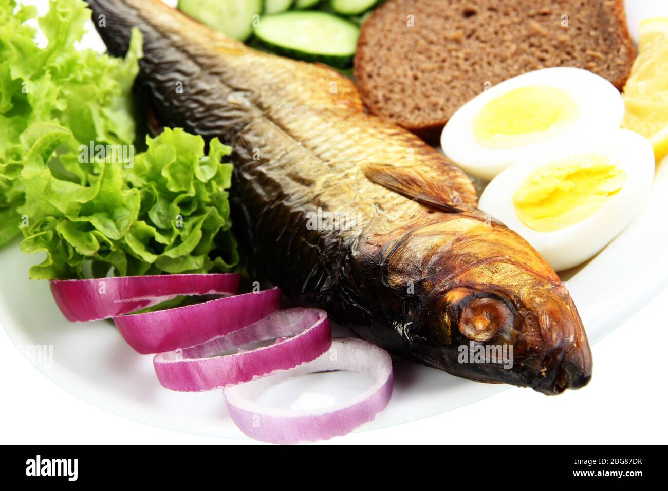Smoked fish on plate close up Stock Photo - Alamy