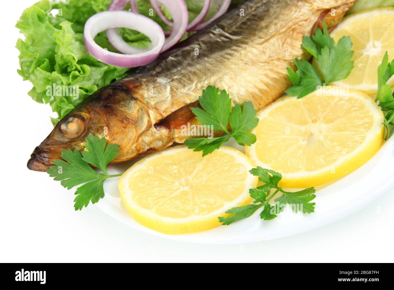 Smoked fish on plate close up Stock Photo - Alamy
