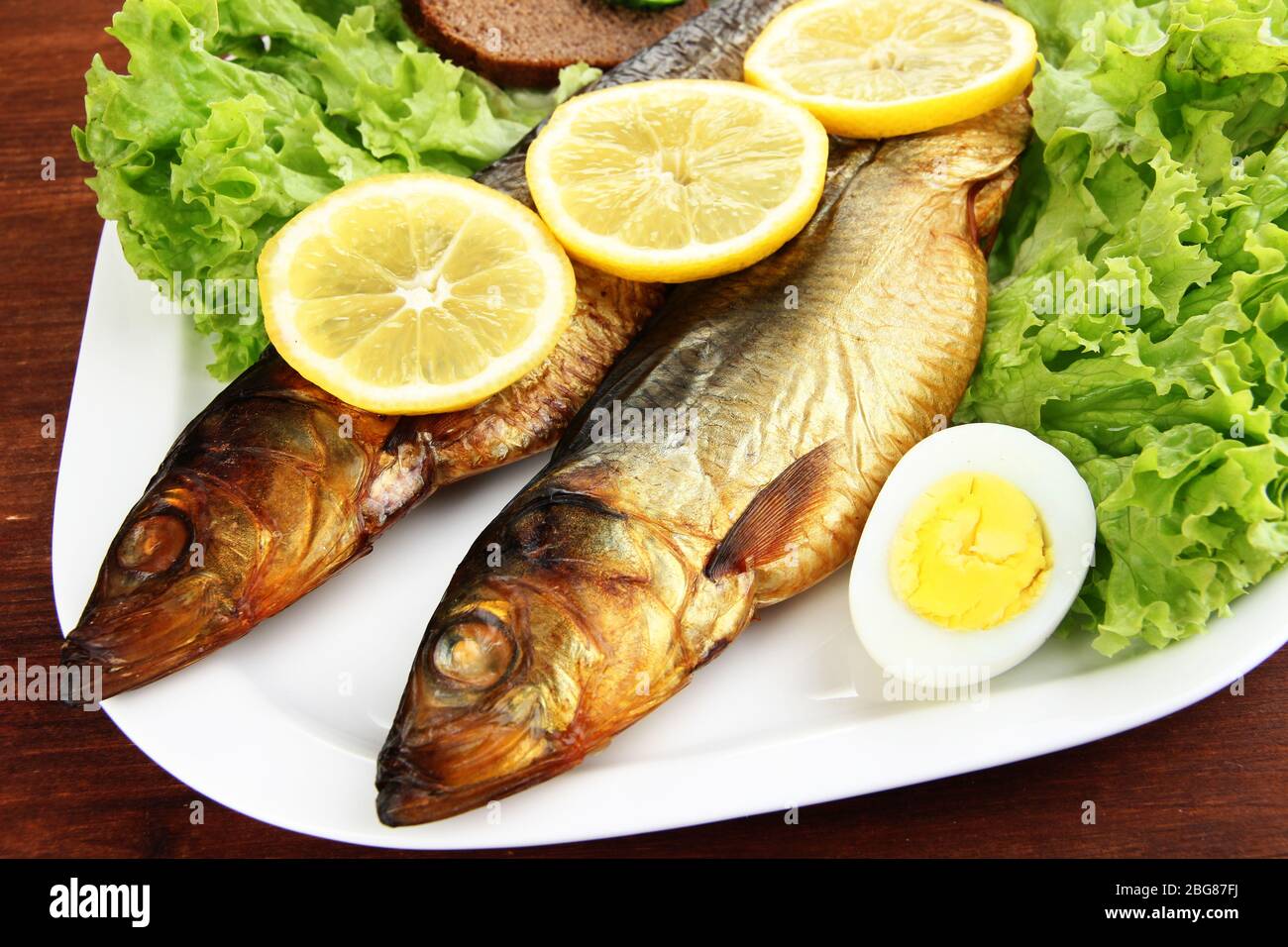 Smoked fish on plate close up Stock Photo - Alamy
