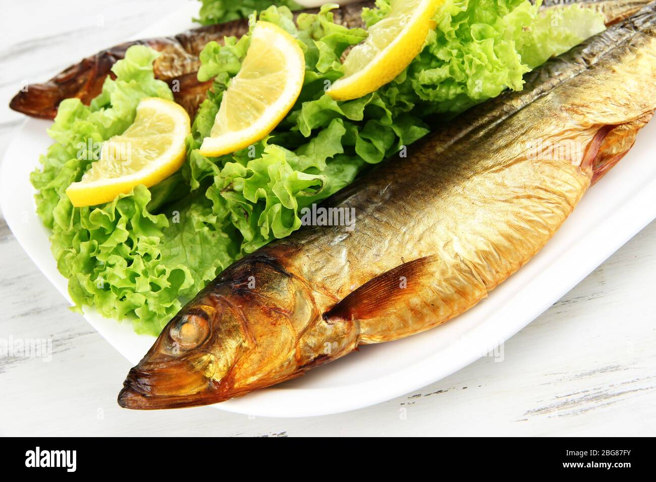 Smoked fish on plate close up Stock Photo - Alamy