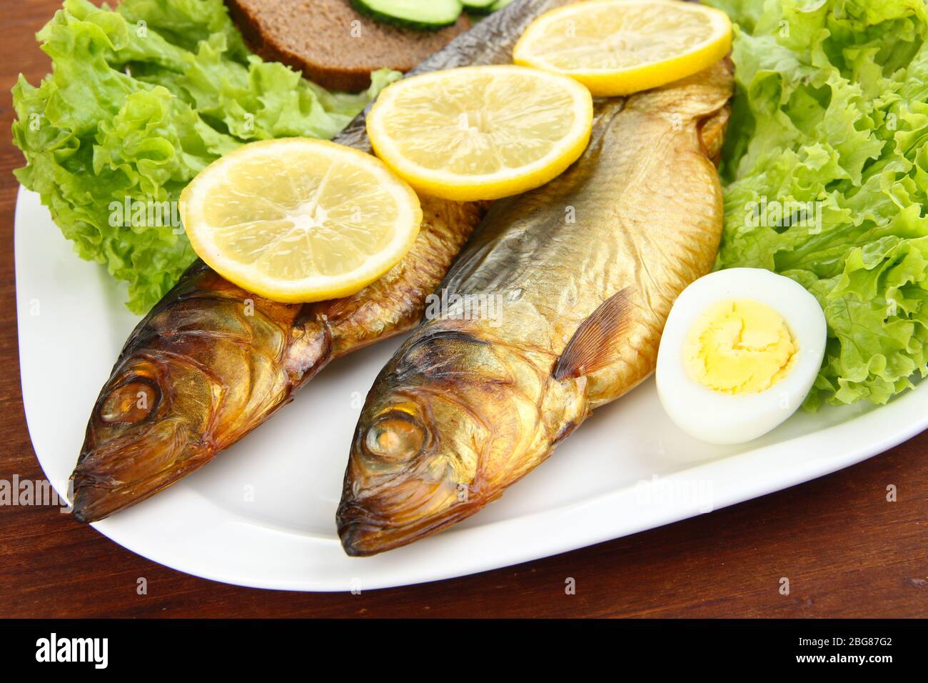 Smoked fish on plate close up Stock Photo - Alamy