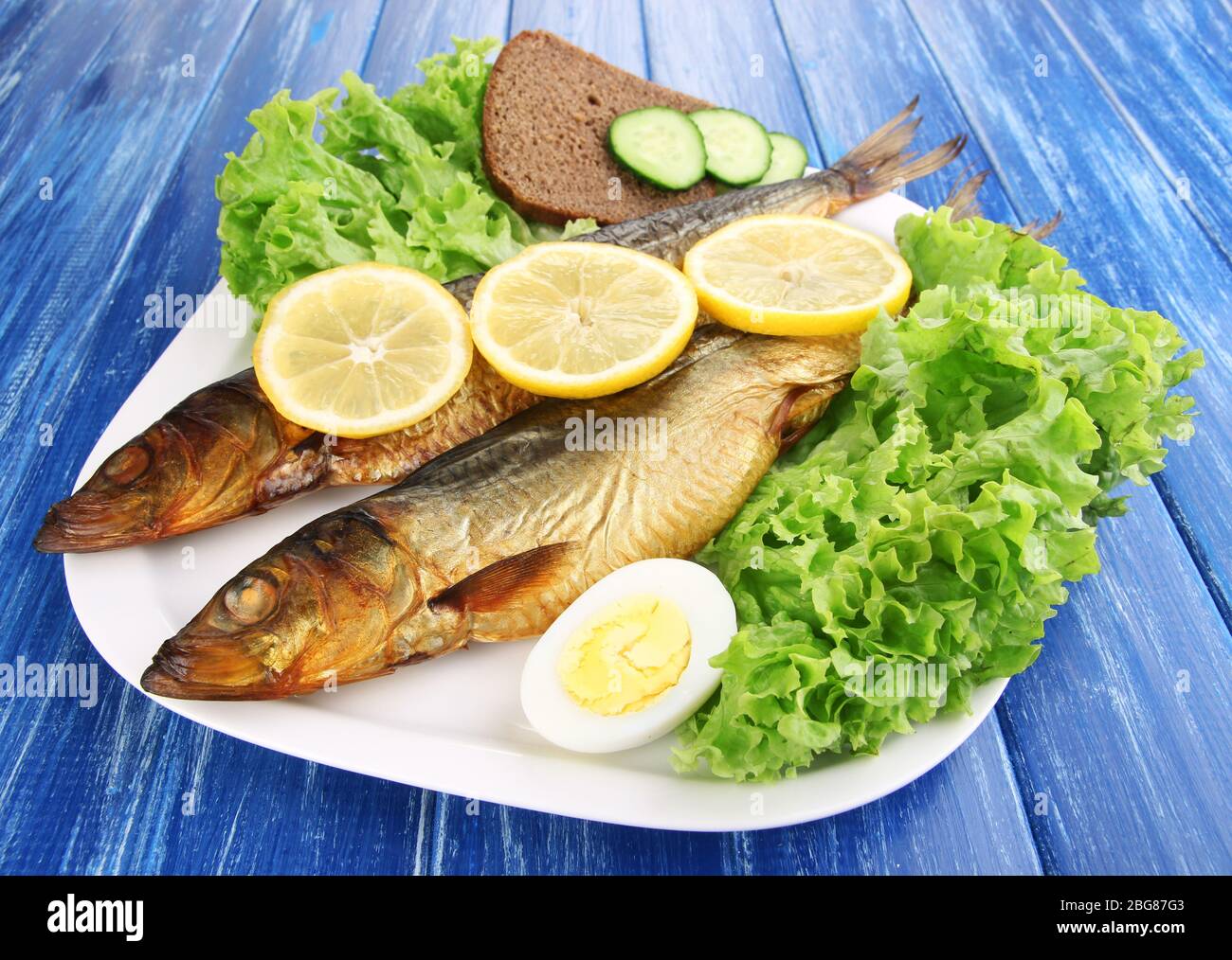 Smoked fish on plate close up Stock Photo - Alamy