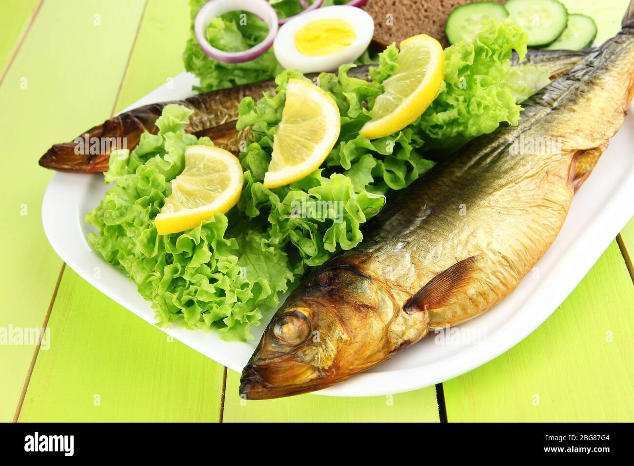 Smoked fish on plate close up Stock Photo - Alamy