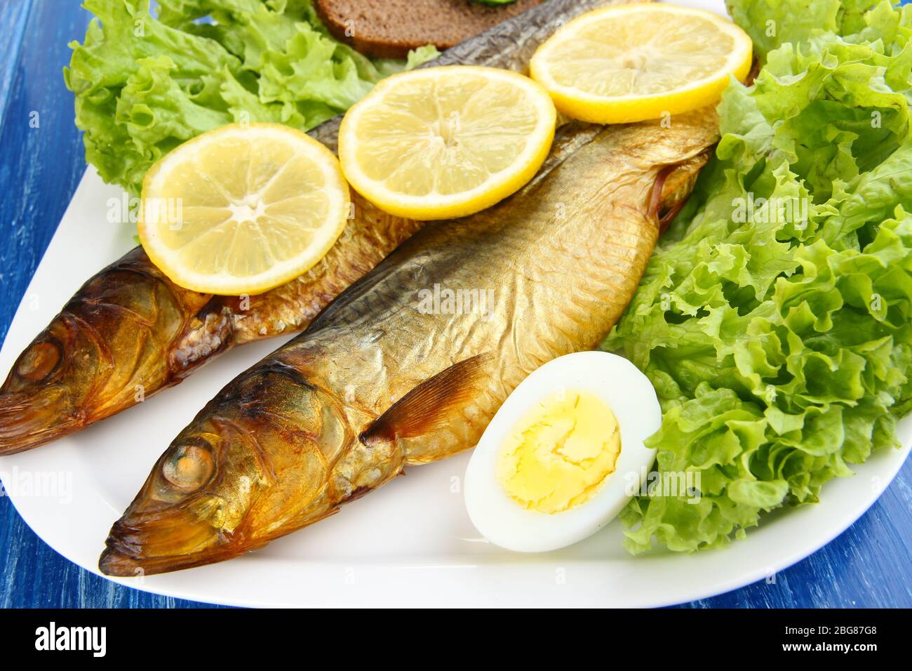Smoked fish on plate close up Stock Photo - Alamy