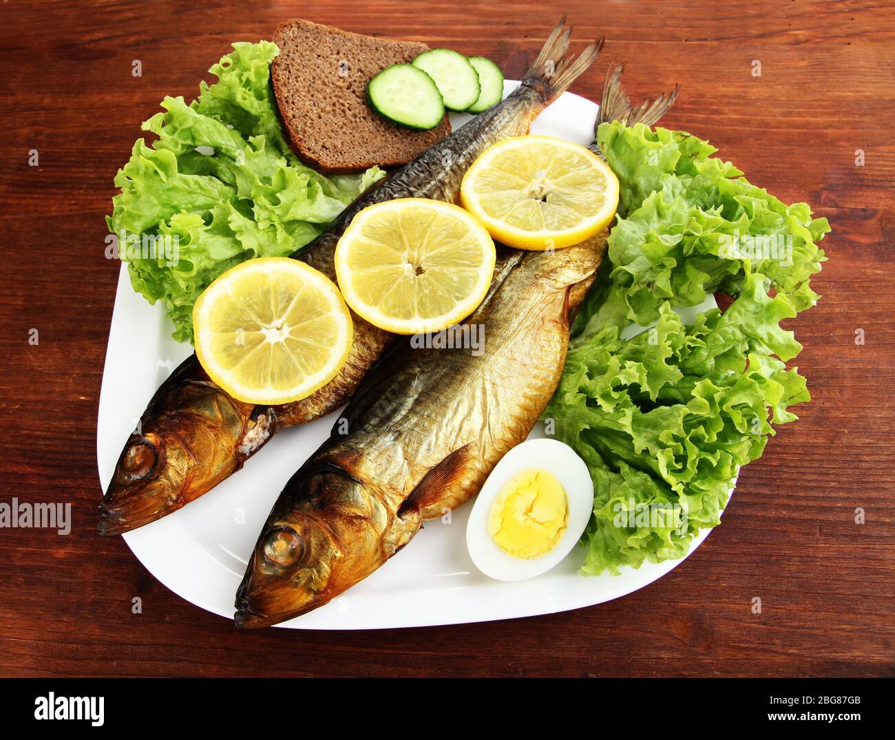 Smoked fish on plate close up Stock Photo - Alamy