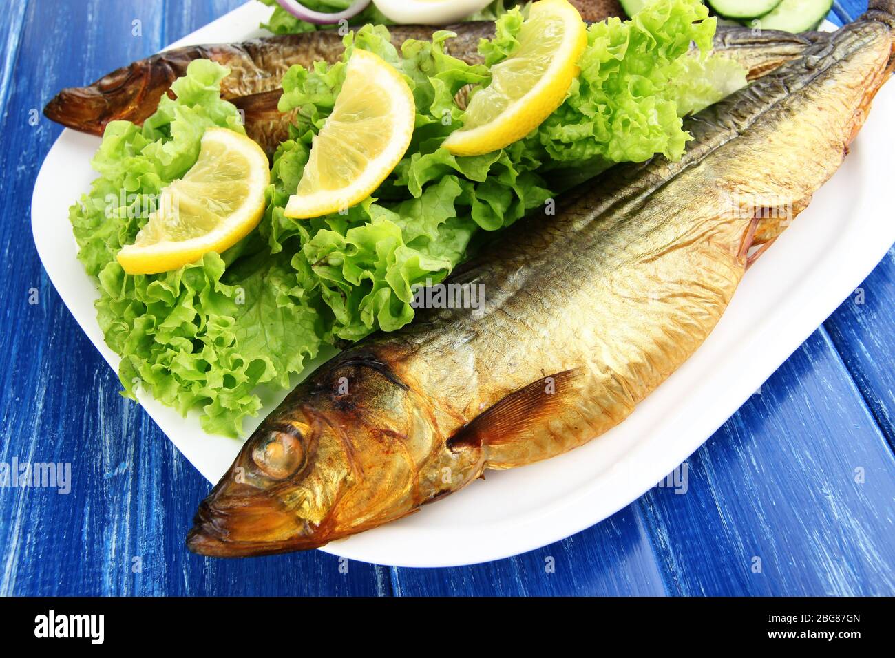 Smoked fish on plate close up Stock Photo - Alamy