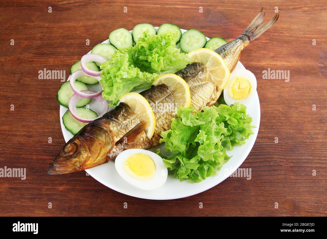 Smoked fish on plate close up Stock Photo - Alamy