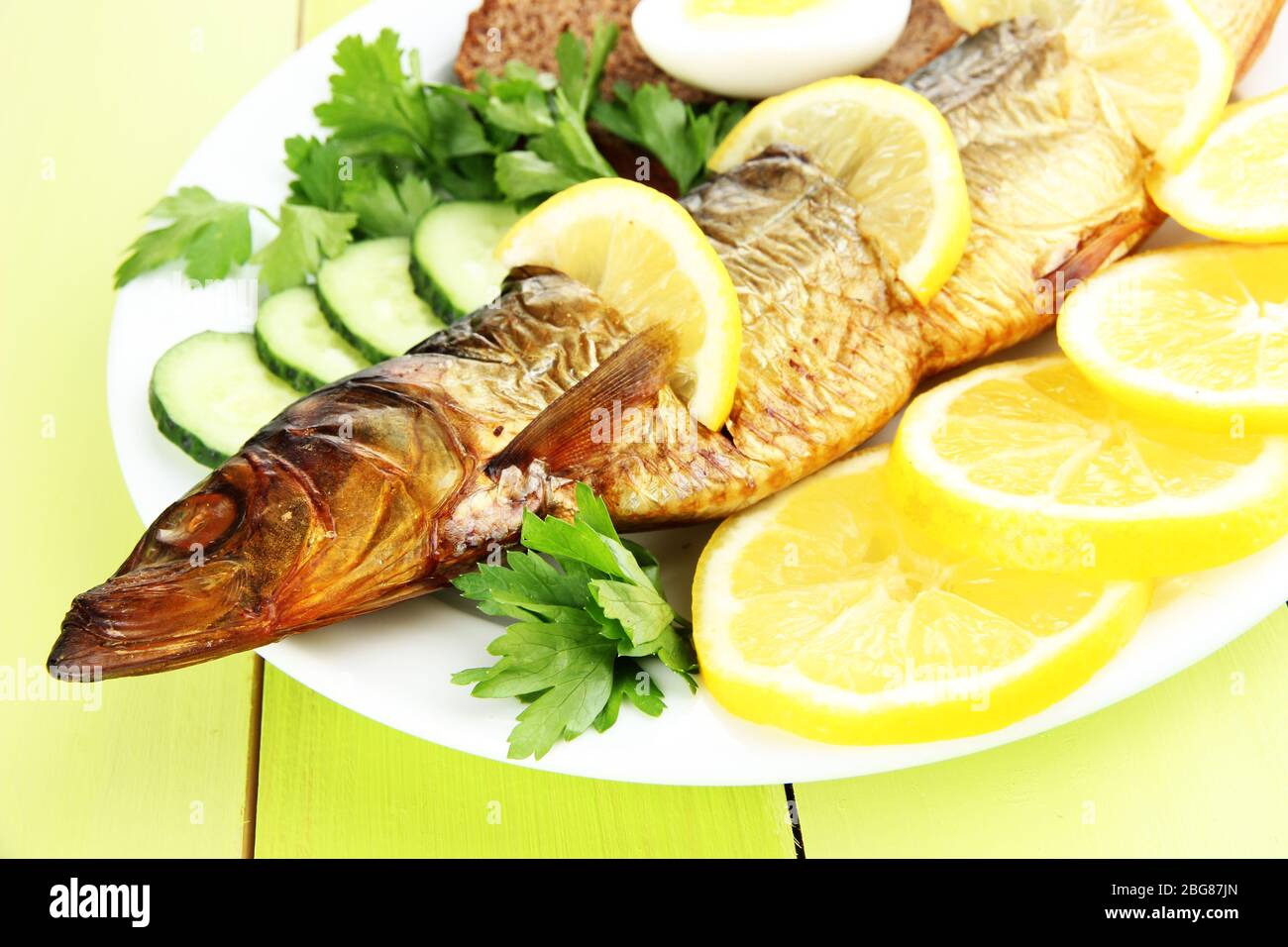 Smoked fish on plate close up Stock Photo - Alamy