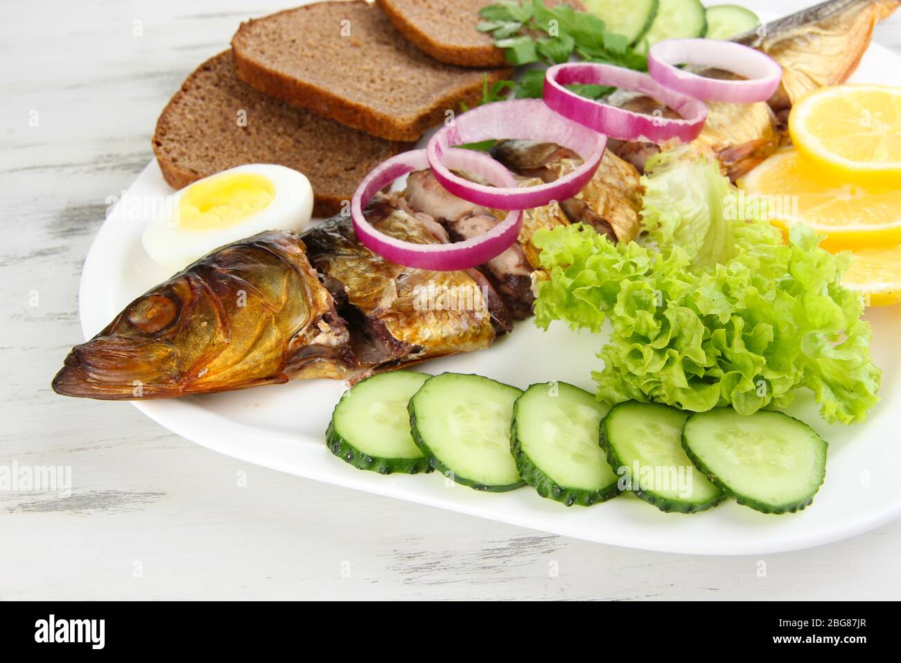 Smoked fish on plate close up Stock Photo - Alamy