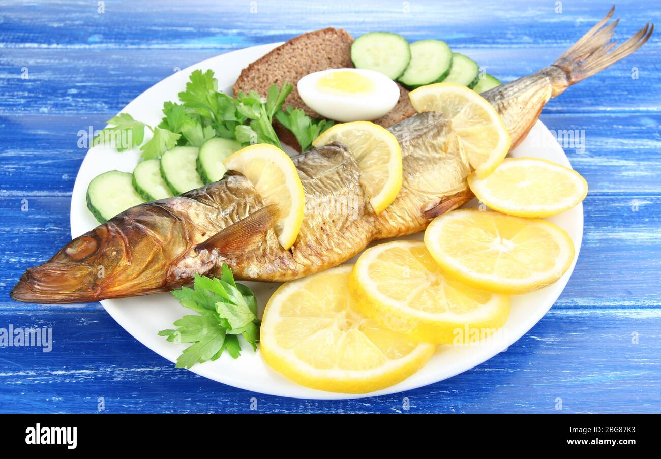 Smoked fish on plate close up Stock Photo - Alamy